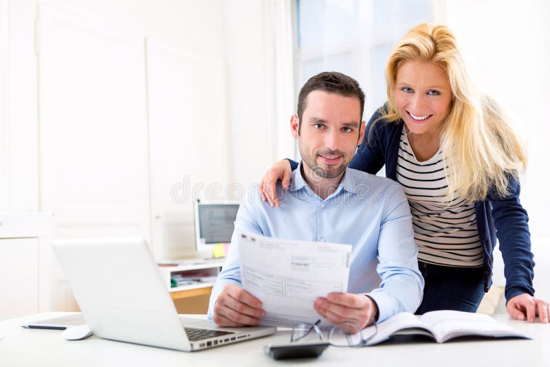 Attractive Couple Doing Administrative Paperwork Stock Image - Image of ...