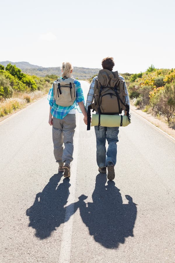 Attractive Couple Walking on the Road Holding Hands Stock Photo - Image ...