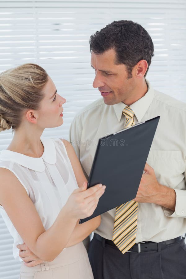 Attractive Coworkers Analyzing Documents Together Stock Photo - Image ...
