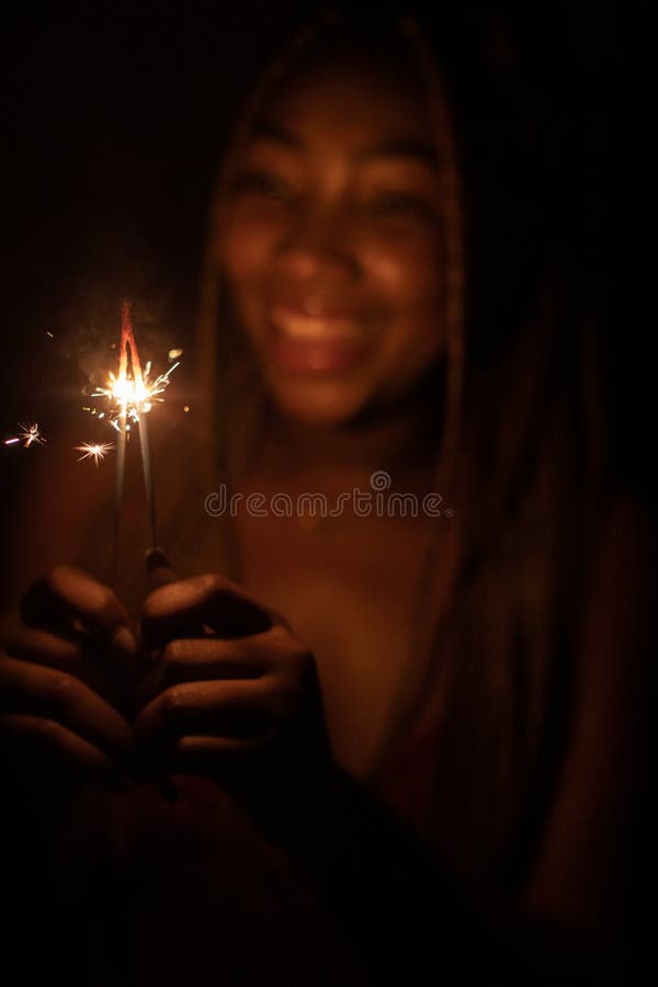 An Attractive Dark Skinned Girl Holds Burning Cold Fires In Her Hand