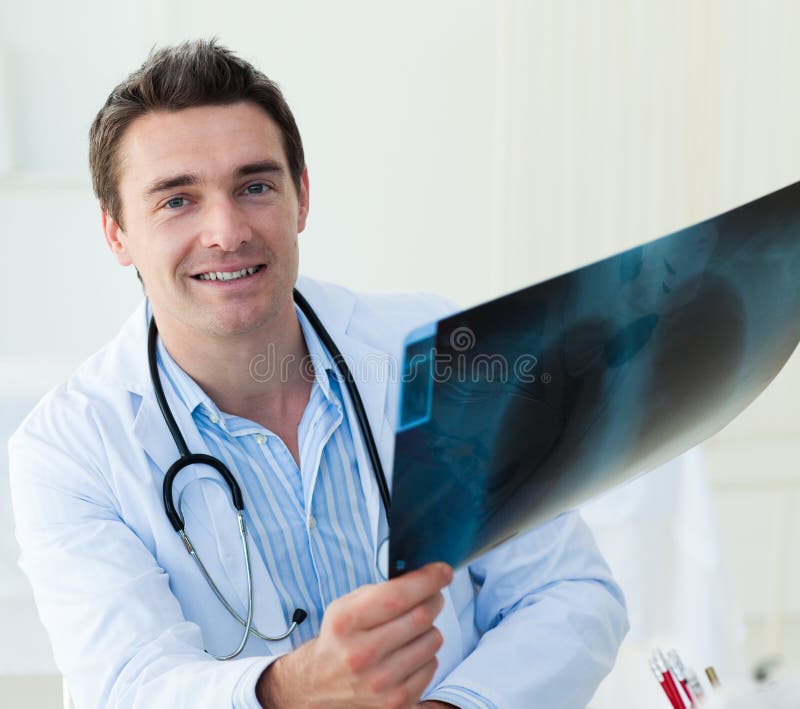 Attractive Doctor Examining an X-ray Stock Photo - Image of radiology ...
