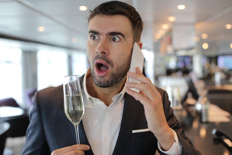 Attractive Elegant Man Shocked while Making a Call from Luxurious Bar ... Attractive Elegant Man Shocked while Making a Call from Luxurious Bar ...