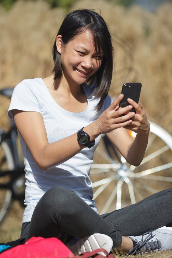 Attractive Female Biker Using Phone Outdoors Stock Photo - Image of ...