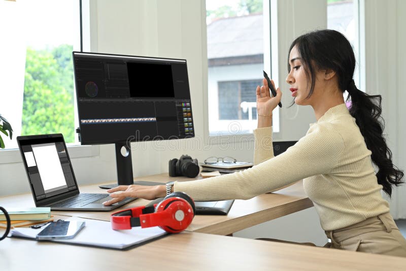 Attractive Female Content Creator Using Laptop, Working with Footage ...