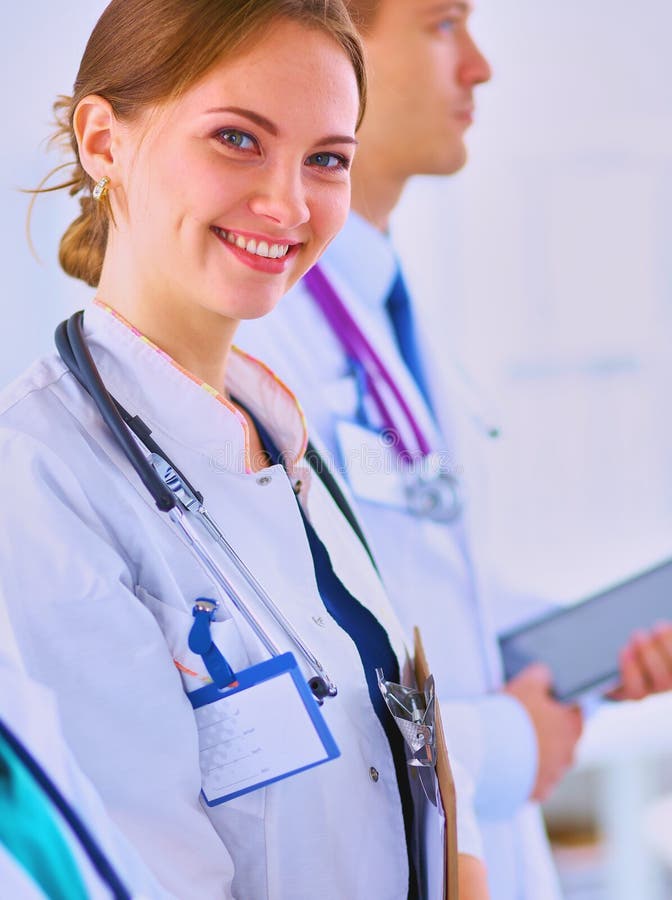 Attractive Female Doctor with Folder in Front of Medical Group Stock ...