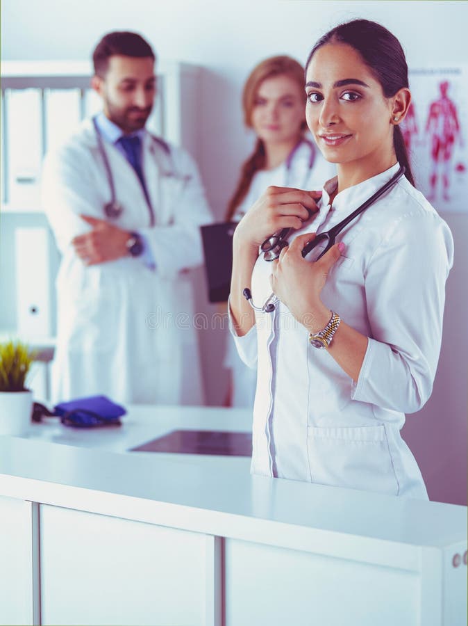 Attractive Female Doctor in Front of Medical Group Stock Photo - Image ...