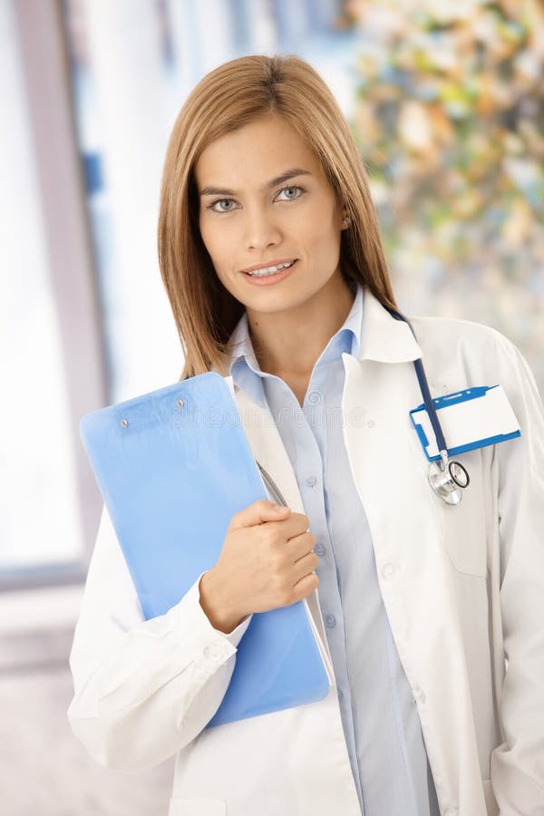 Attractive Doctor Writing Report Sitting at Desk Stock Image - Image of ...