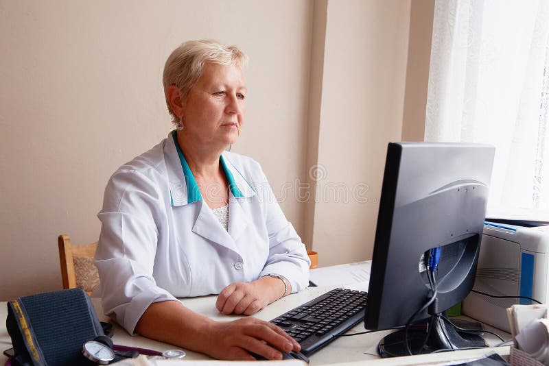 Attractive Female Doctor Working on Her Computer in Her Office Stock ...