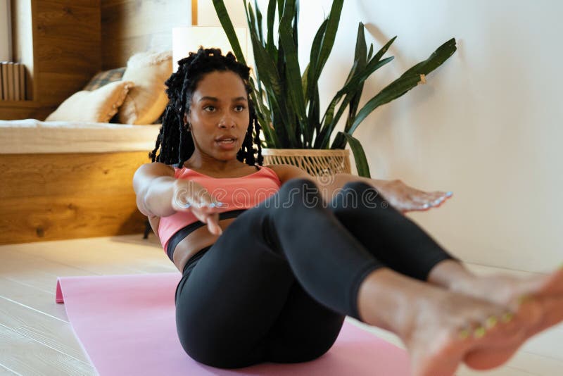 Attractive Female Doing Exercise in Her Living Room. she Doing Abs ...