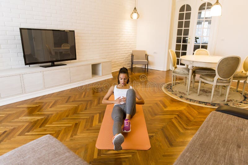 Attractive Female Doing Exercise in Her Living Room Stock Photo - Image ...