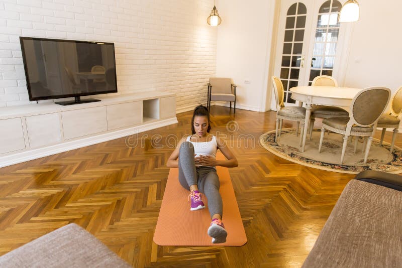Attractive Female Doing Exercise in Her Living Room Stock Image - Image ...