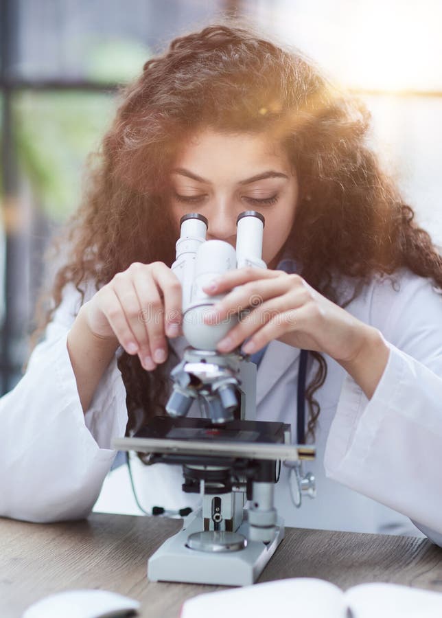 Attractive Female Scientist Looking through a Microscope Stock Photo ...