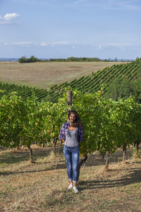 Attractive Female Winemaker Wearing Casual Clothes among the Vines in ...