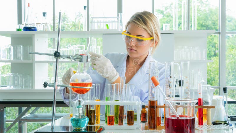 Attractive Female Young Scientist Smiling and Looking in Table ...