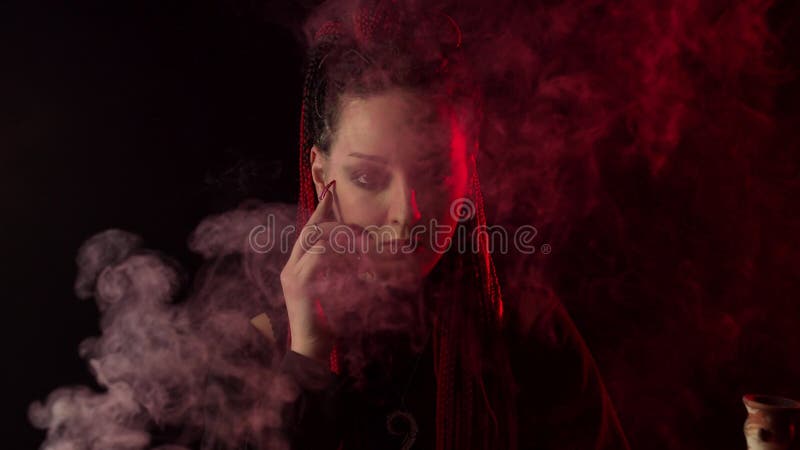 Attractive Girl with Braids Touching Face in Smoke Stock Footage ...