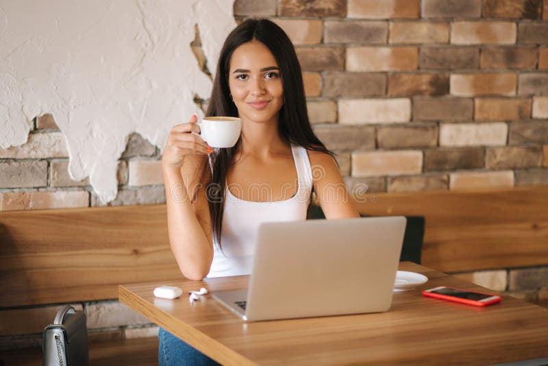 Attractive Girl Working on Laptop in Cafe. Beautiful Girl Using ...