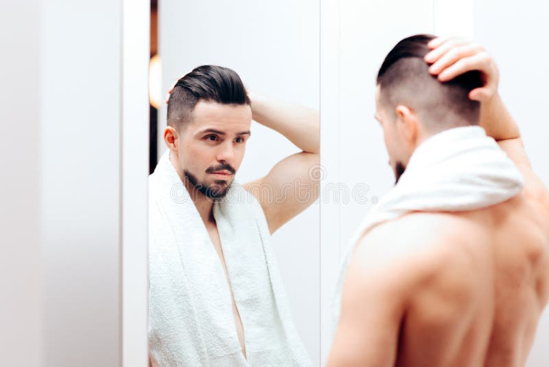 Handsome Man Checking Himself in the Mirror Stock Photo - Image of ...