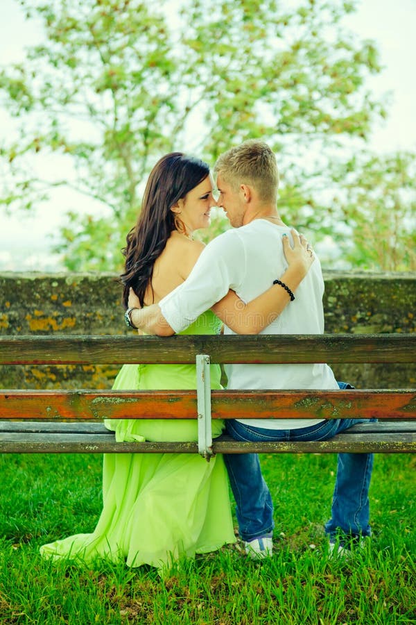 Attractive the Guy with the Girl Sit and Embrace on a Bench Stock Image ...