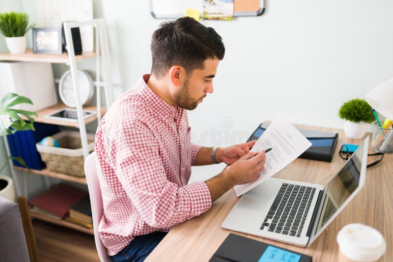 Attractive Guy Reviewing Some Work Documents in His Office Stock Photo ...