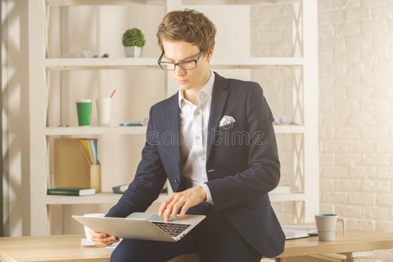 Attractive Guy Using Laptop Stock Photo - Image of desk, coffee: 94097252