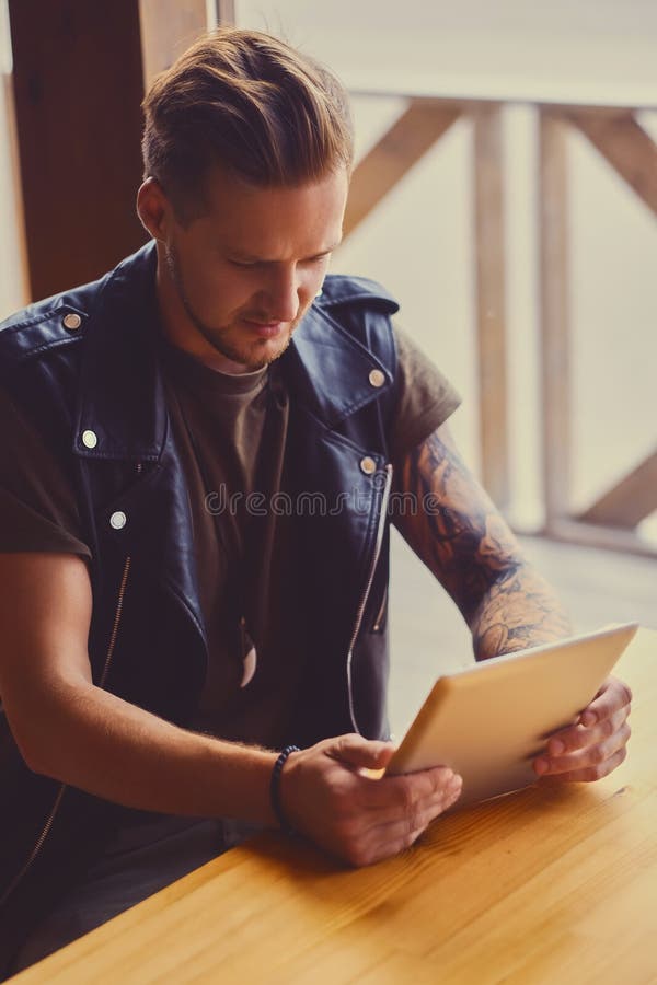 Attractive Guy Using a Tablet PC in a Cafe Near the Window. Stock Image ...