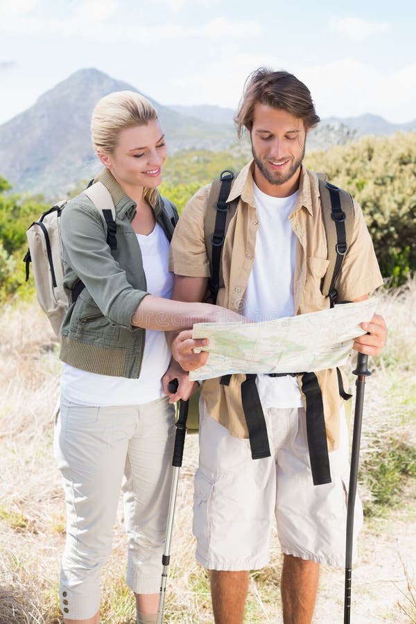 Attractive Hiking Couple Reading the Map on Mountain Trail Stock Photo ...