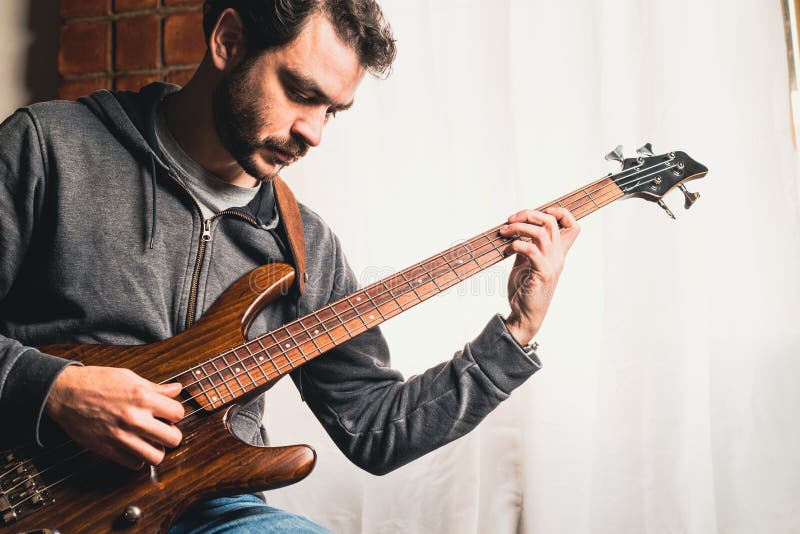 Attractive, Hispanic Man Playing Electric Bass Guitar Stock Image ...