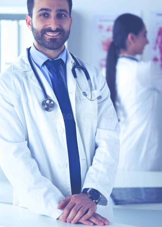 Attractive Male Doctor in Front of Medical Group Stock Photo - Image of ...