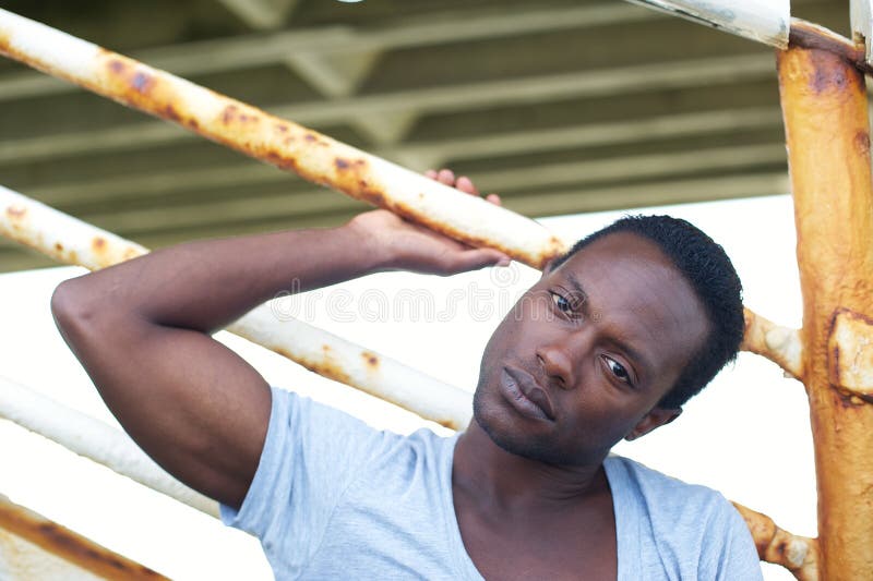 Attractive Male Model Sitting Outdoors and Looking at Camera Stock ...