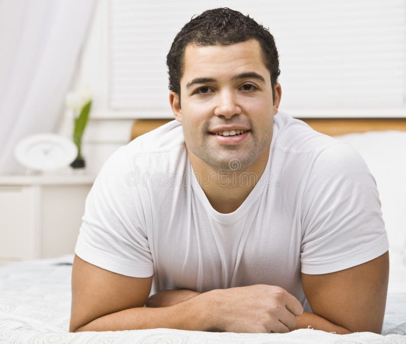 Attractive man on bed stock photo. Image of inside, american - 9913592