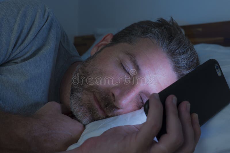 Attractive Man Falling Asleep on Bed Late at Night in Dark Light while ...