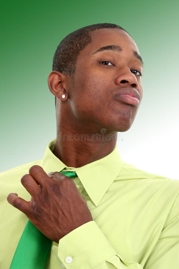 Attractive Man In Green Adjusting Necktie Over Green Background Stock ...