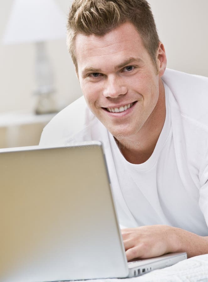 Smiling Guy Using Laptop Computer Stock Photo - Image of adult, indoors ...