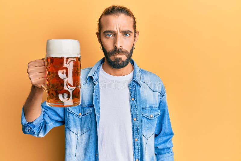 Attractive Man with Long Hair and Beard Drinking a Pint of Beer ...