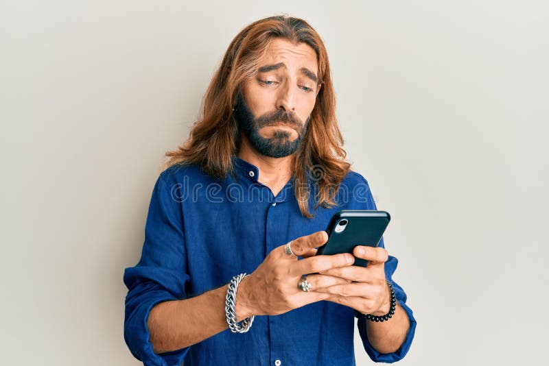 Attractive Man with Long Hair and Beard Using Smartphone Depressed and ...
