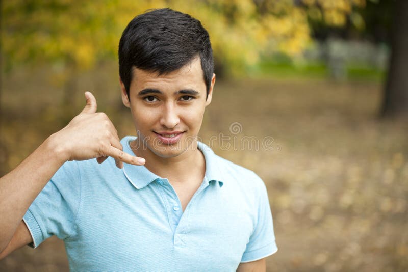 Attractive Man Making a Call Me Gesture, Outdoors Autumn Park Stock ...