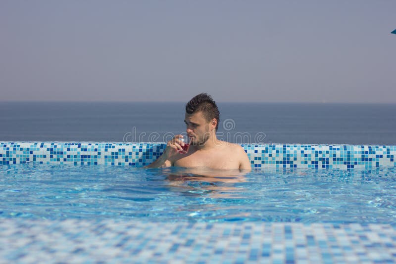 Attractive Man in the Pool with a Cocktail. Stock Image - Image of blue ...