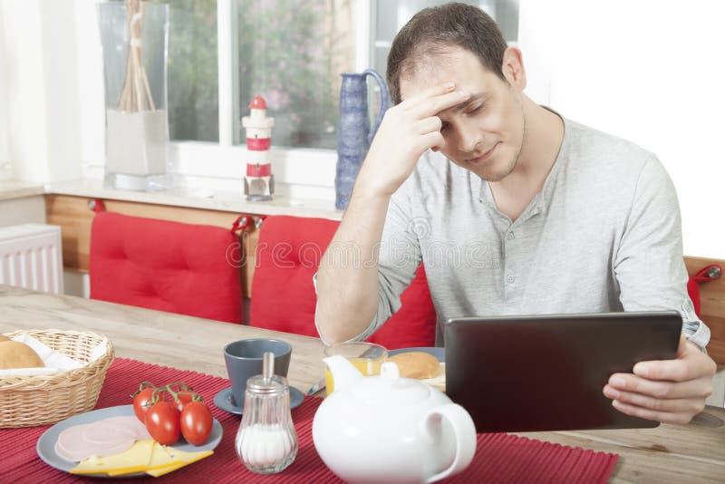 Attractive Man Reading His Tablet at the Table Stock Image - Image of ...