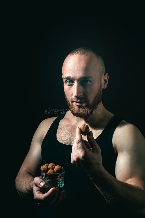 Attractive Man with Serious Face Hold Walnut Nuts. Stock Photo - Image ...