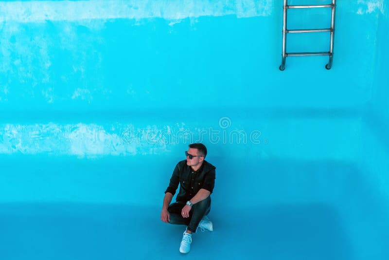 Attractive Man is Siting in Empty Swimming Pool Stock Image - Image of ...
