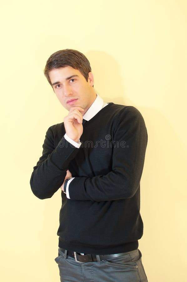 Attractive Man Standing and Thinking Against Wall Stock Photo - Image ...