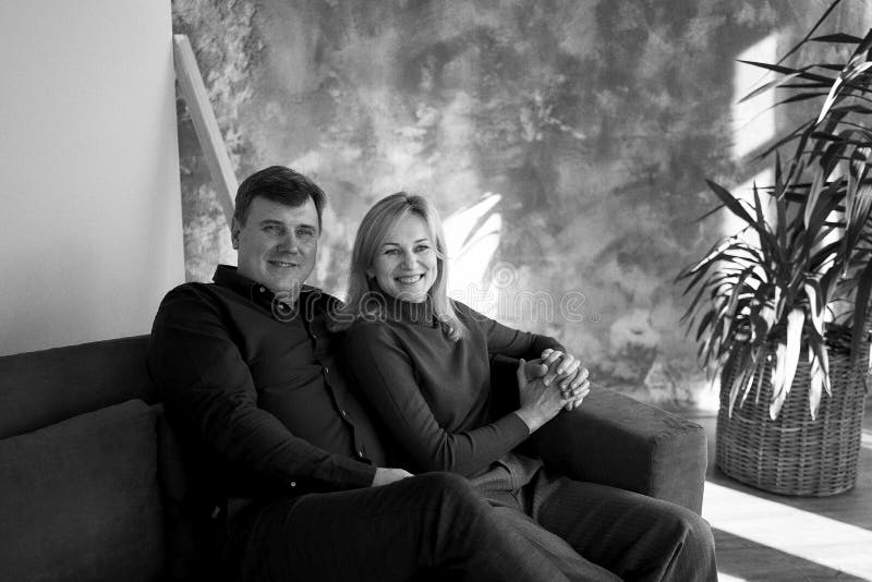 Attractive Middle-aged Married Couple Hugging and Smiling on Sofa ...
