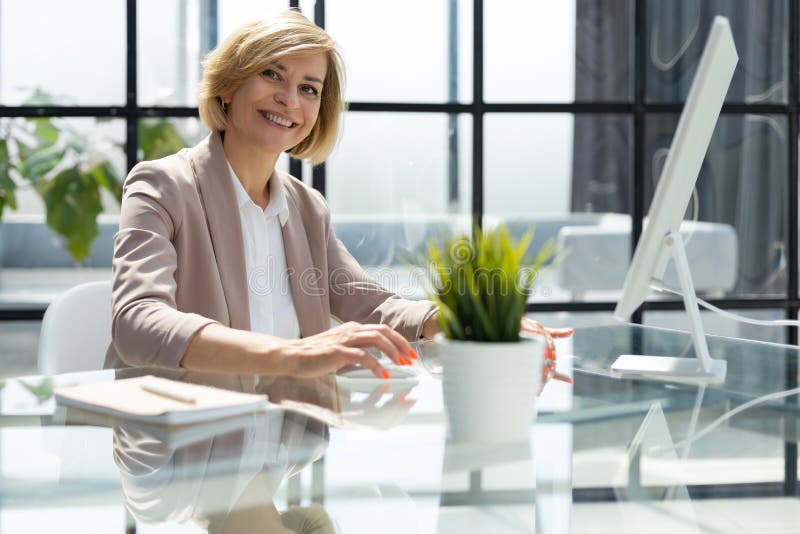 Attractive Middle Aged Woman Working at Office, Using Contemporary ...
