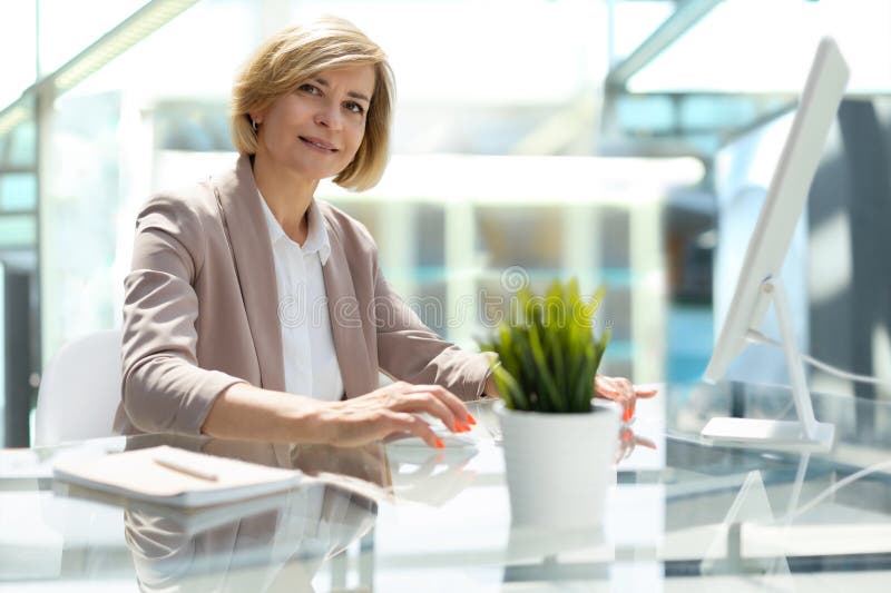 Attractive Middle Aged Woman Working at Office, Using Contemporary ...