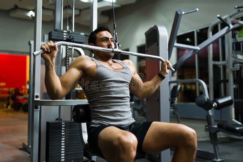 Strong Young Man Working Out Stock Photo - Image of machine, fitness ...