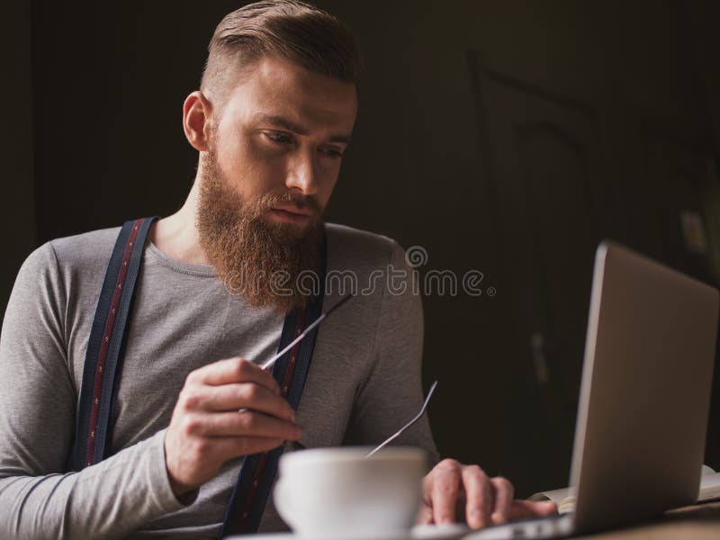 Cheerful Bearded Guy is Working with a Laptop Stock Photo - Image of ...