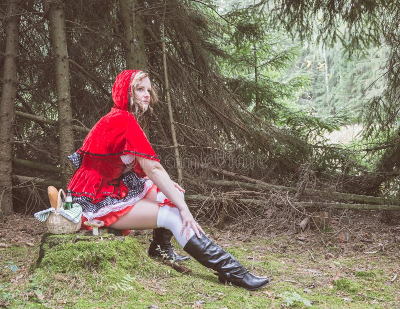 Attractive Red Riding Hood Sitting in the Forest Stock Photo - Image of ...