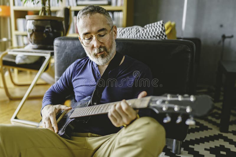 A Attractive and Relaxed Looking Man Playing the Guitar Stock Image ...