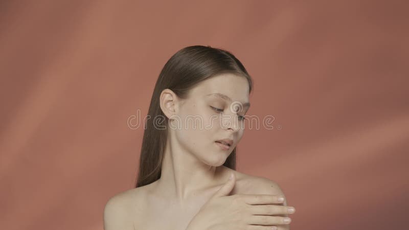 Attractive Seminude Woman Applies Rubs Body Cream Into The Skin Of Her