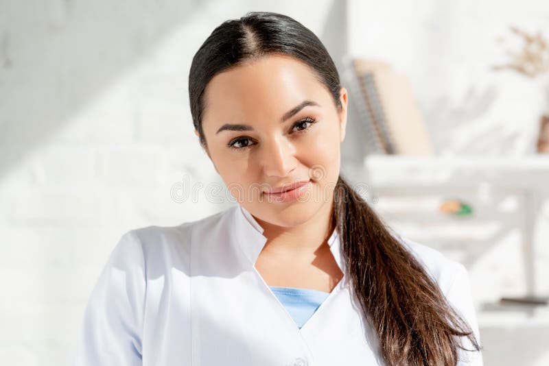 Attractive and Smiling Dermatologist Looking at Stock Photo - Image of ...